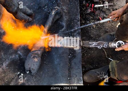 Burning camel's skin with torch, Morocco Stock Photo - Alamy