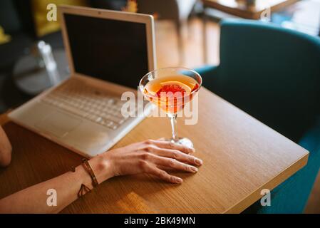 A glass of margarita cocktails and a laptop on the table Stock Photo ...
