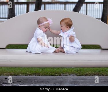 Babies hanging out together in the park Stock Photo - Alamy
