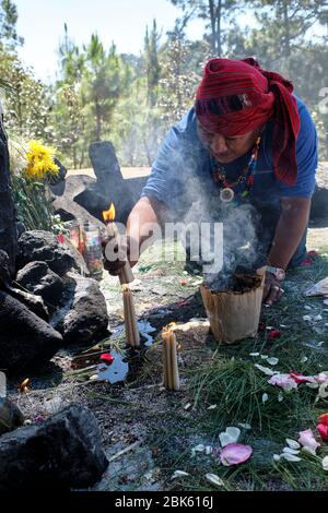 Shaman performing a Mayan healing ceremony for a family on the top of ...