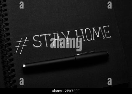 Stay at home, text. Headline inscription on black paper background ...