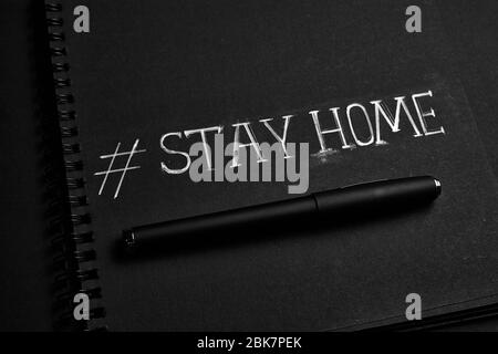 Stay at home, text. Headline inscription on black paper background ...