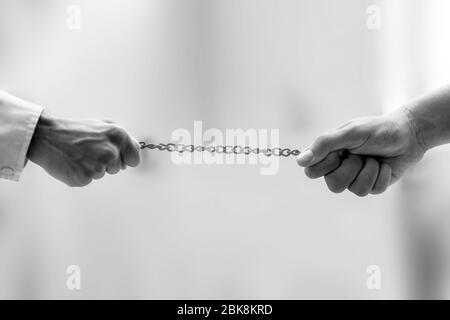 Two Hands Pulling A Chain Stock Photo - Alamy
