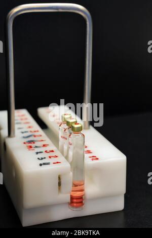 Quality Control vials for injection. Individual checks vial under a ...