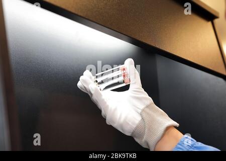 Quality Control vials for injection. Individual checks vial under a ...