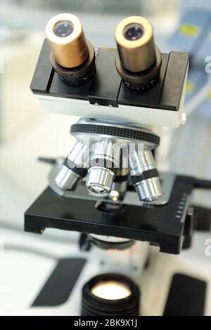A woman and a man study the structure of the drug pellets under a ...