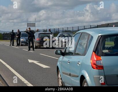 PSNI officers pictured at a vehicle checkpoint, engaging the public on ...
