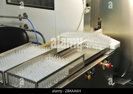 Visual control of ampoules with medicine. A woman works on an ampoule ...