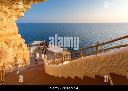 Coastal view of a terrace at Cova d'en Xoroi, a bar and night club set ...