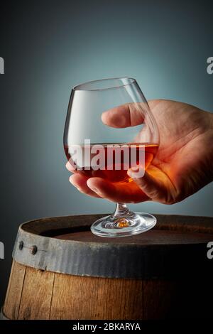 Glass of cognac on grey background Stock Photo - Alamy