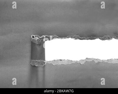 Gray ripped paper revealing cardboard Stock Photo - Alamy