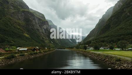 Small lake and rock against the cloudy sky Stock Photo - Alamy