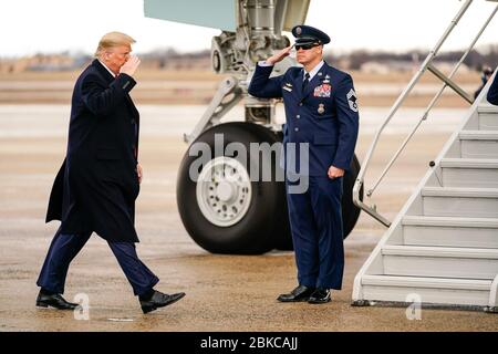 President Donald Trump salutes while boarding Marine One after arriving ...