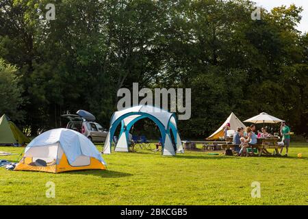 Wide shot of busy camping field at Wowo's, a family campsite in Sussex ...