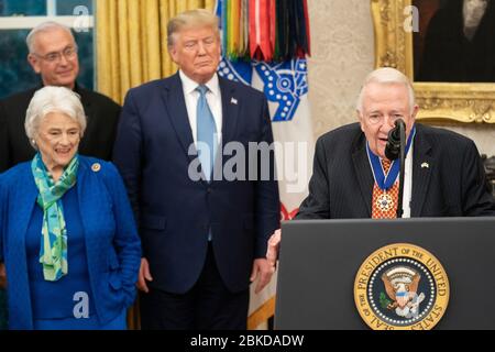 President Donald Trump presents a medal to 2025 Kennedy Center Honoree ...
