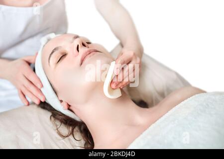 beautician cleanses skin of beautiful woman with a sponge Stock Photo ...