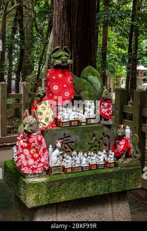 Kitsune fox deities, Kashima Jingu forest, Kashima, Japan. Inari is the ...