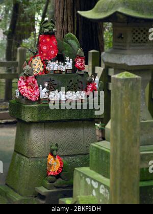 Kitsune fox deities, Kashima Jingu forest, Kashima, Japan. Inari is the ...