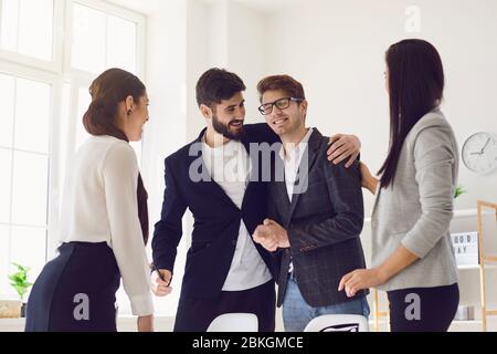 Employees working in team at table Stock Photo - Alamy