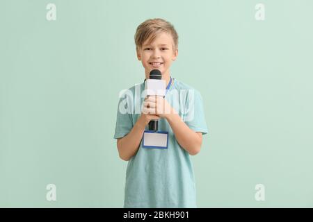 Little journalist with microphone on color background Stock Photo - Alamy