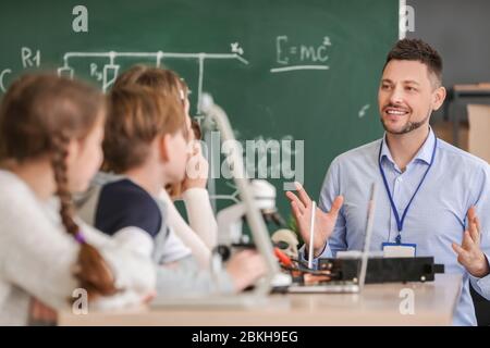 Teacher conducting physics lesson in classroom Stock Photo - Alamy