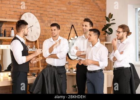 Professional hairdresser teaching young men in salon Stock Photo - Alamy