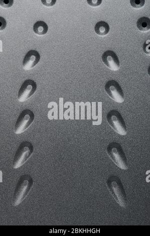 Holes on the bottom of an iron Stock Photo - Alamy
