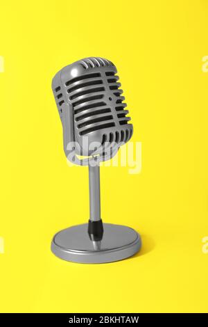 Retro microphone on color background Stock Photo - Alamy
