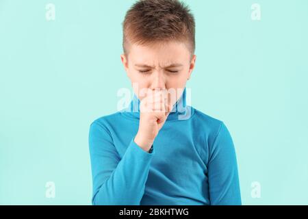 Little boy coughing on color background. Immunity system fighting with ...