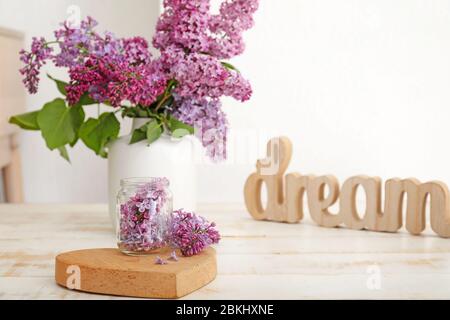 Beautiful lilac flowers on table in kitchen Stock Photo - Alamy