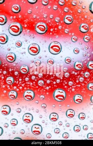 Lips close-up through drops of water on glass Stock Photo - Alamy