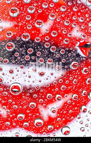 Lips close-up through drops of water on glass Stock Photo - Alamy