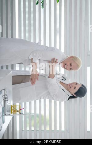 Two doctors in white robes standing in the room Stock Photo - Alamy