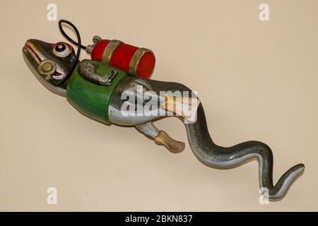 Statue of gecko with diving equipment on the wall of diving center. 3D ...