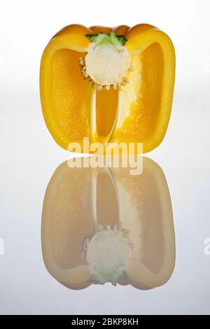 Yellow pepper cut in half showing internal flesh and seeds Stock Photo ...