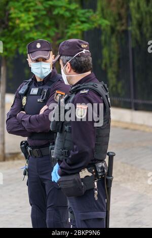 Policemen wearing face masks to protect against coronavirus patrol in ...
