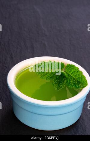 Mint jelly in small pot on black stone background Stock Photo - Alamy