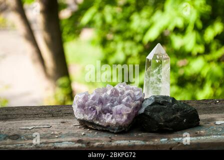 Coal, amethyst, quartz. Natural crystal without processing on a green ...