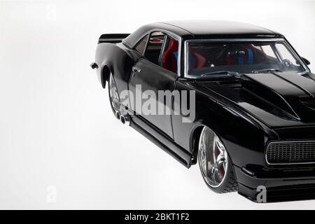 Front side view of a black modified Land Rover Defender pickup crawling ...