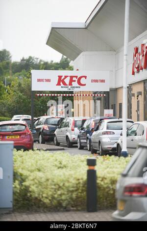 Cars queue for the drive thru at a KFC fast food restaurant during the ...