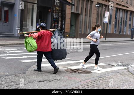 A woman walks along an almost empty Tidal Basin lined with cherry ...