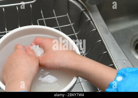 kid washing rice in a kitchen Stock Photo - Alamy