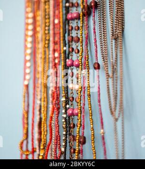 Strings of coloured beads hanging Stock Photo - Alamy