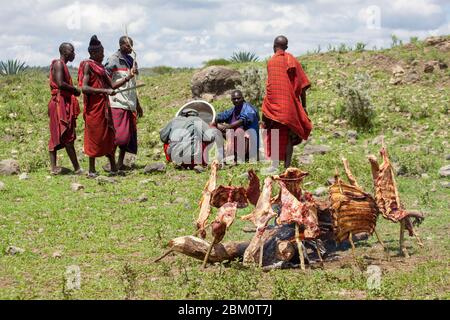 Masai man cooking Stock Photo - Alamy
