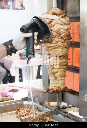A chicken shawarma skewer roasting on a rotating pole Stock Photo - Alamy