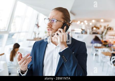 Image of serious concentrated handsome young man surfer with oars at ...