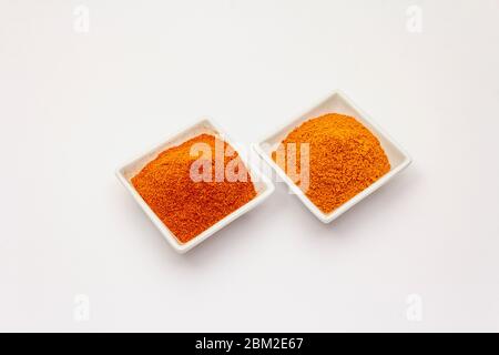 Two types of Hungarian paprika powder, hot and sweet, isolated on white ...