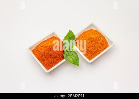 Two types of Hungarian paprika powder, hot and sweet, isolated on white ...