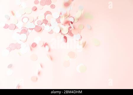 Multicolor pink, gold and white confetti on the bright pink background ...