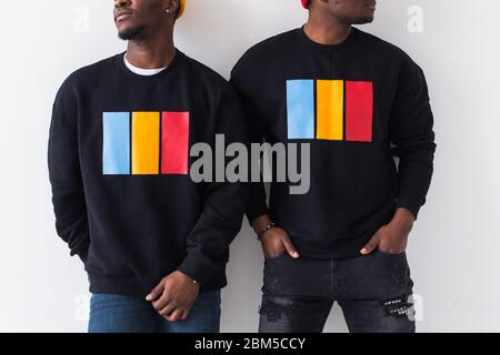 Two angry friends after a quarrel sitting on a couch and looking at the ...